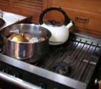 Using Pot Restraints on a Boat Stove - The Boat Galley